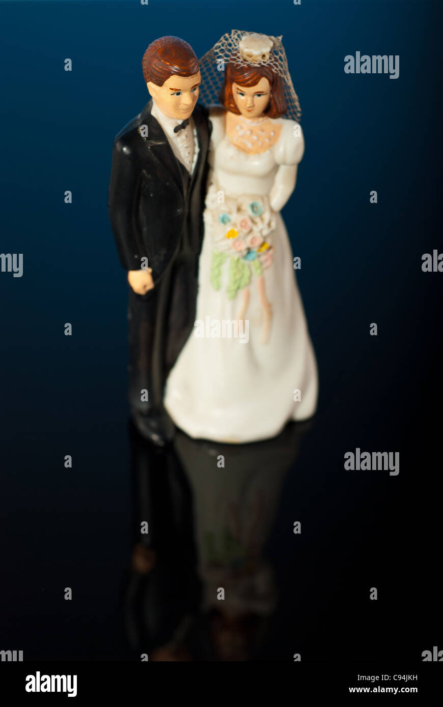 Miniature bride and groom for wedding cake decoration on black ...