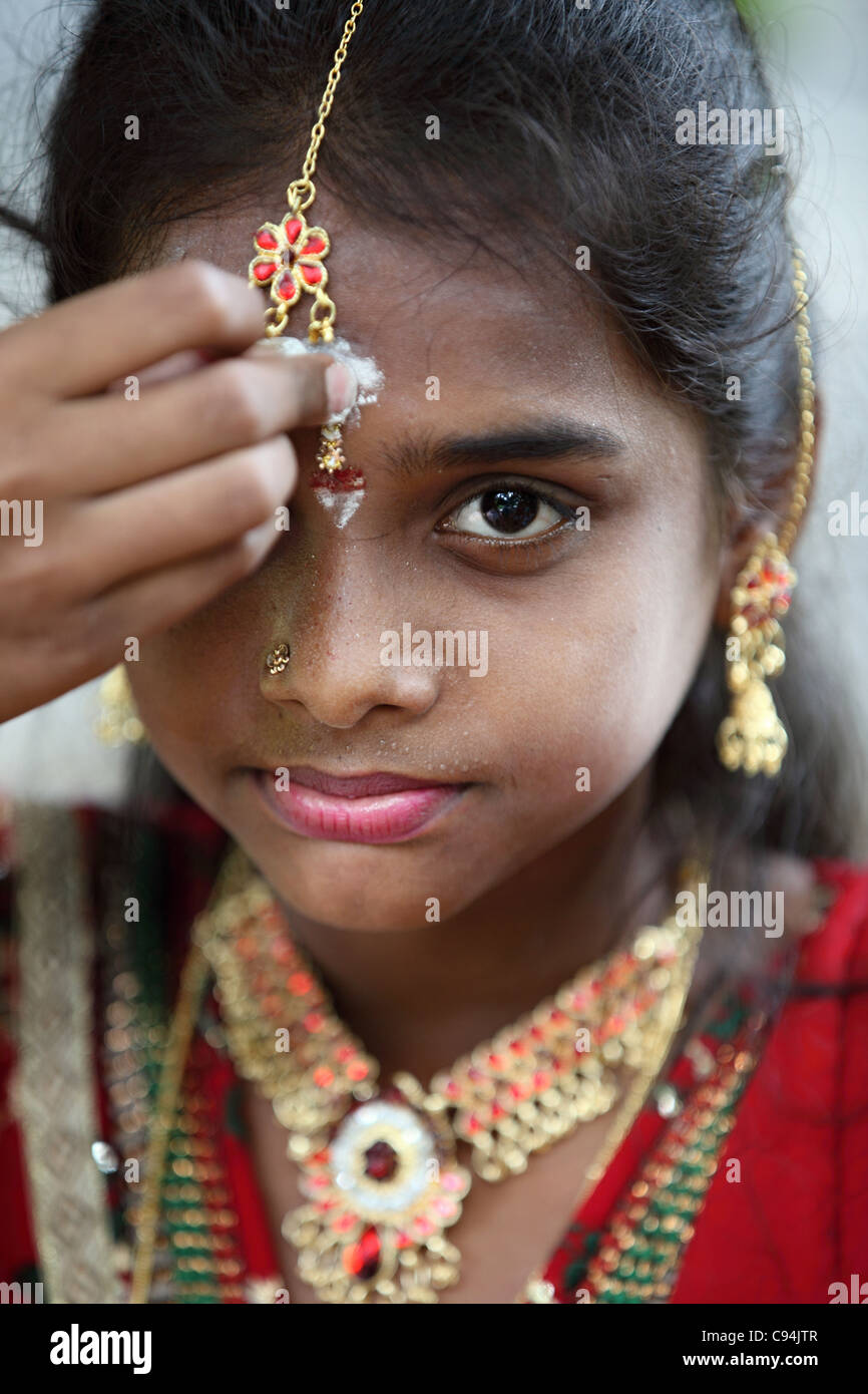 Girl applying vibhuti on the forehead India Stock Photo - Alamy