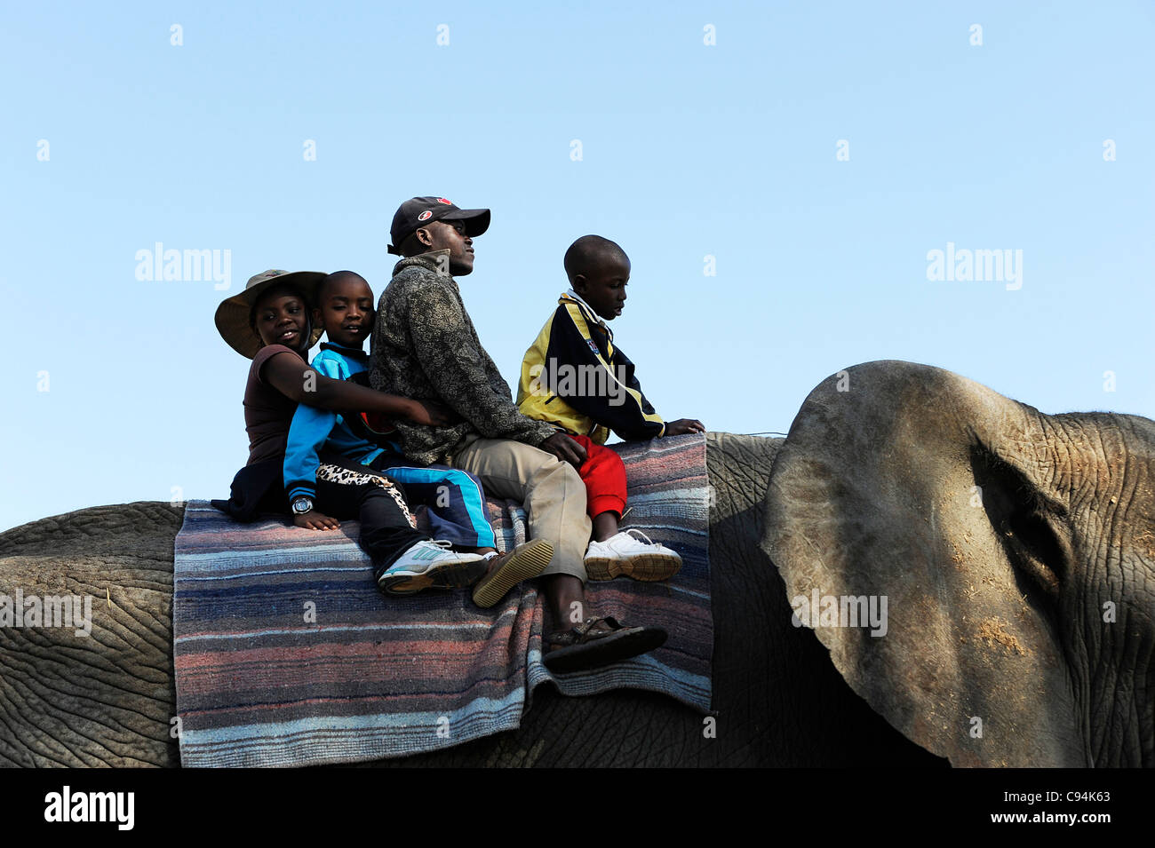 Children riding elephants bare-back in Imire Safari Ranch, Zimbabwe ...