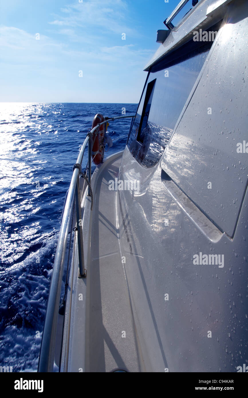 Boat side sailing in blue sea with sun reflection in water Stock Photo ...