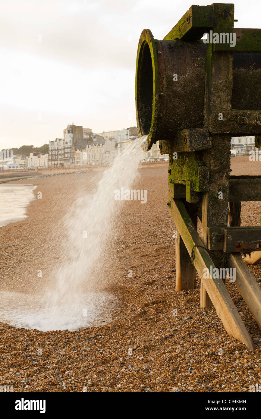 Storm overflow running directly onto a beach when the tide is out Stock ...