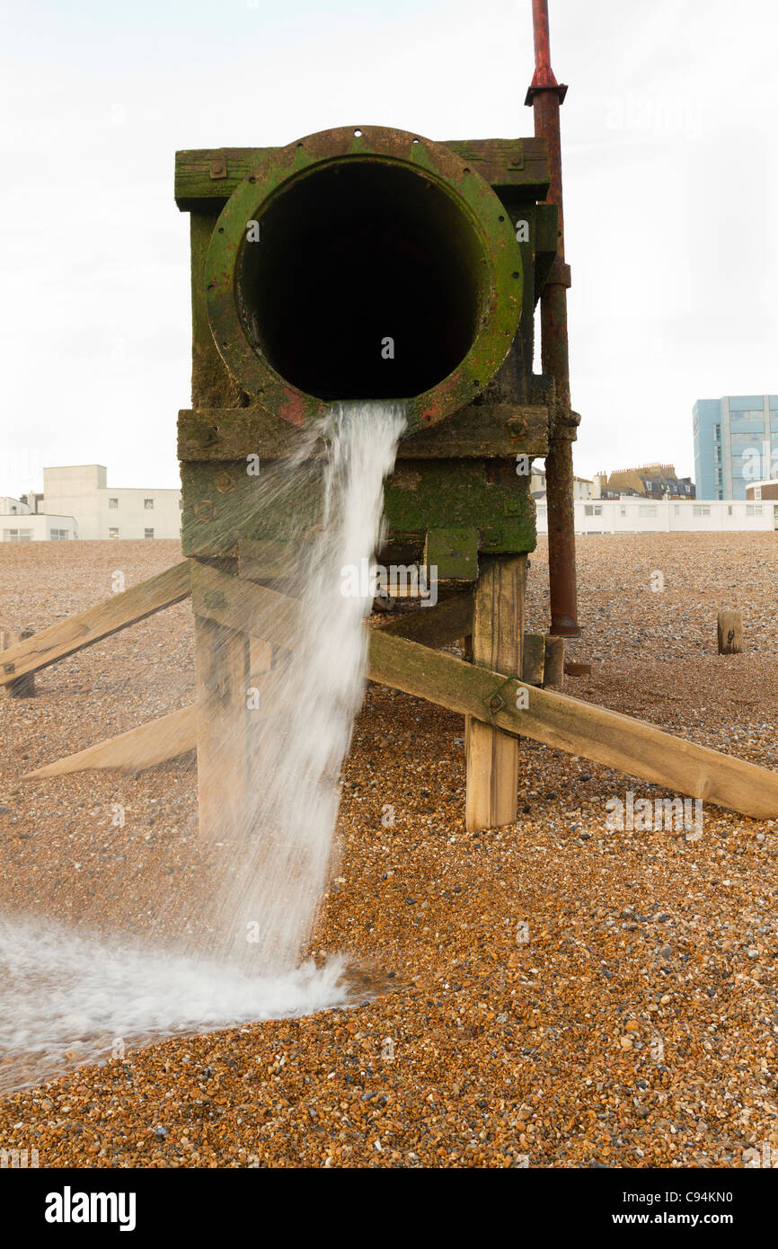 Storm overflow running directly onto a beach when the tide is out Stock ...