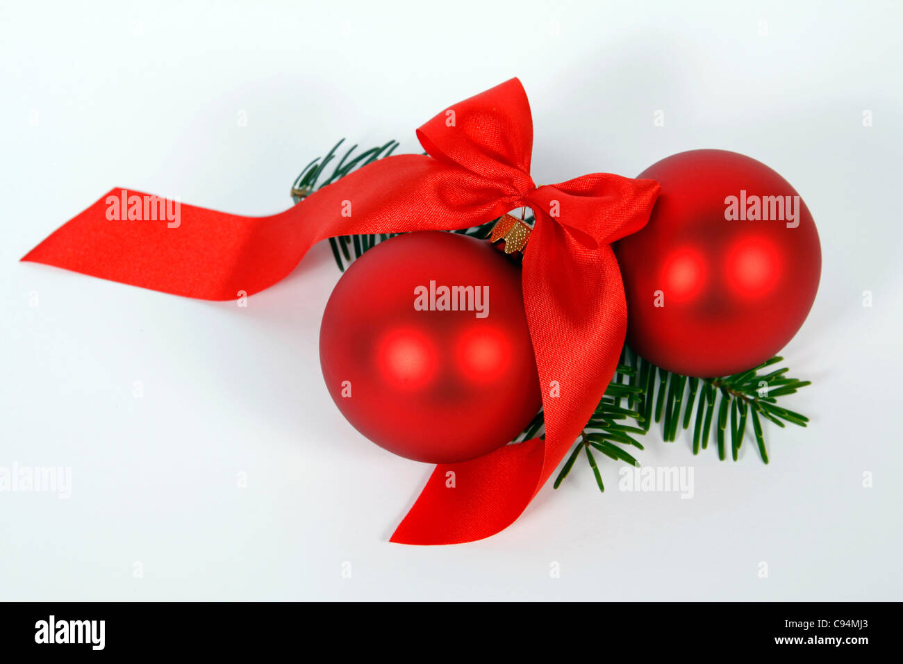 Red baubles with the ribbon on the white background Stock Photo - Alamy