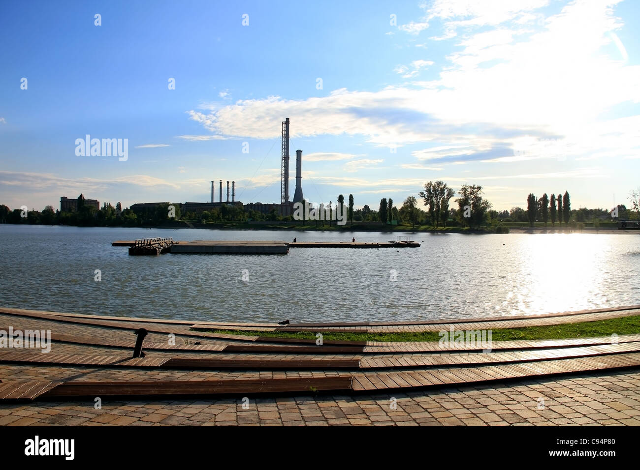 Industrial view in suburban area over lake to factory towers Stock ...