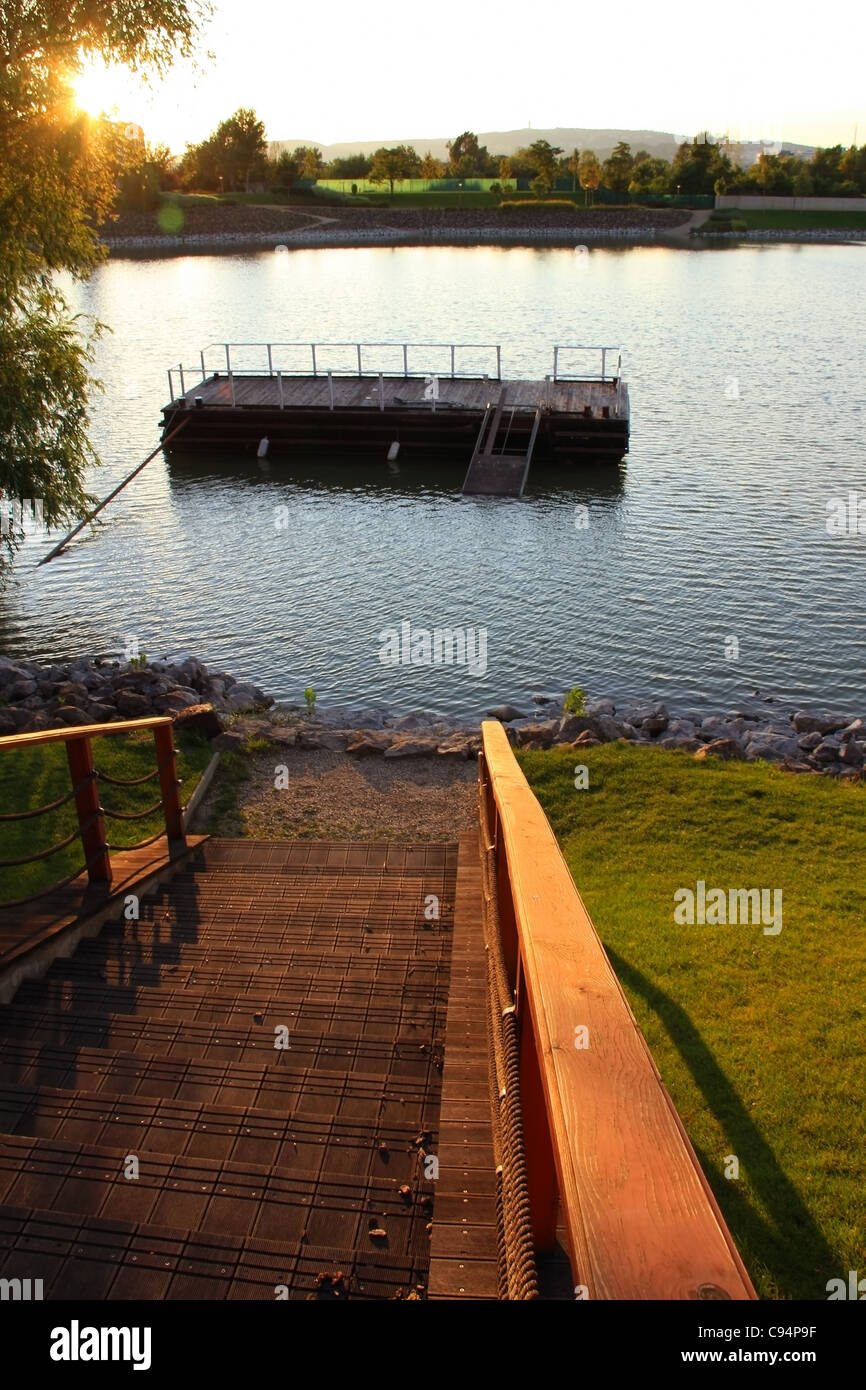 Looking down on stairs to a beautiful sunset above a lake Stock Photo ...