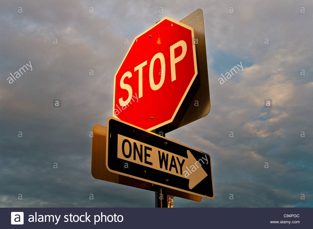 Stop sign and one way sign at sunset, Seattle, Washington, USA Stock ...