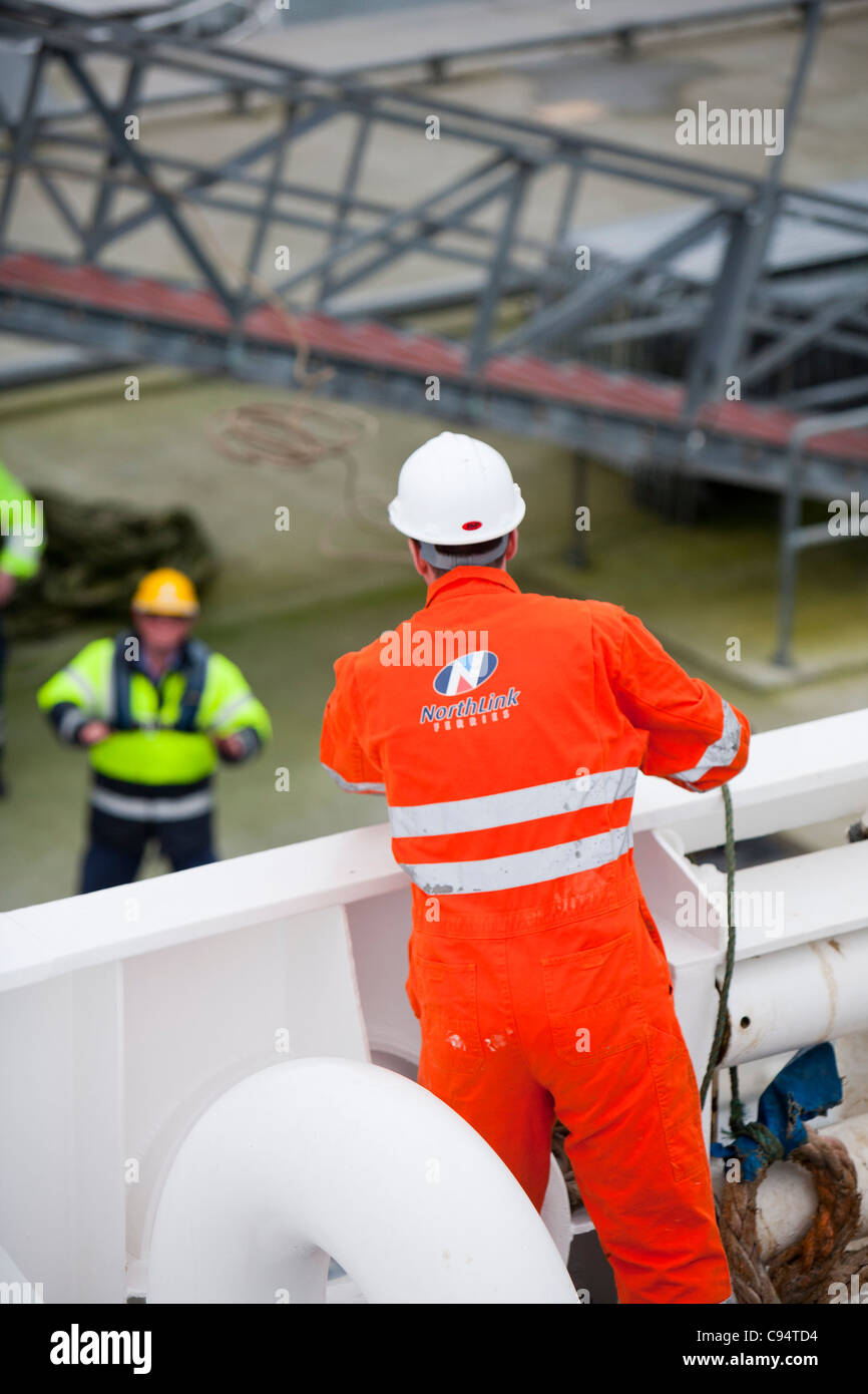 A deck hand throws a mooring rope to shore on a Northlink ferry in ...