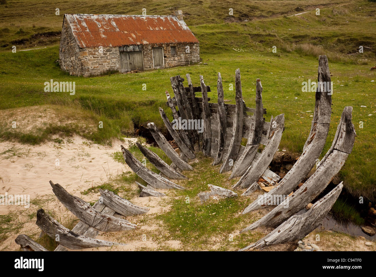Boat wreck in front of fishermans cottage Melness Scotland Stock Photo ...