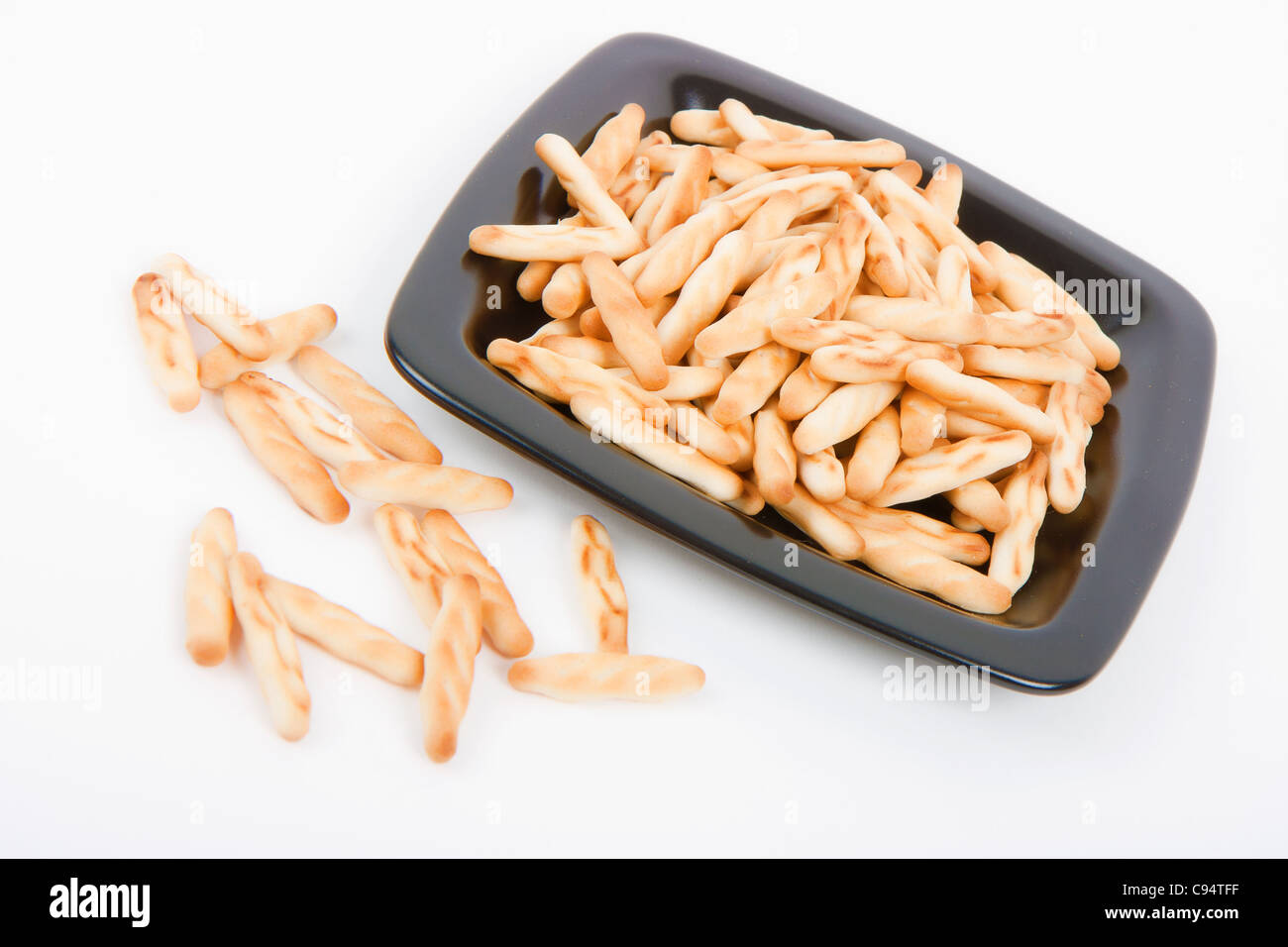 salted sticks on a plate. Snack on a white background Stock Photo - Alamy