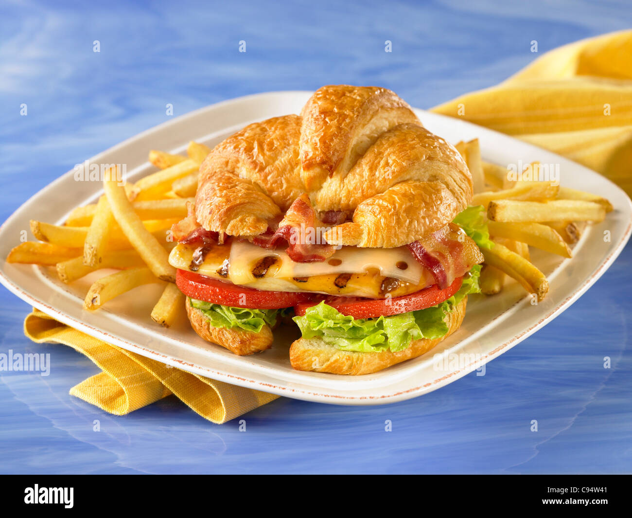 Gourmet croissant chicken sandwich with bacon, lettuce, tomato and ...