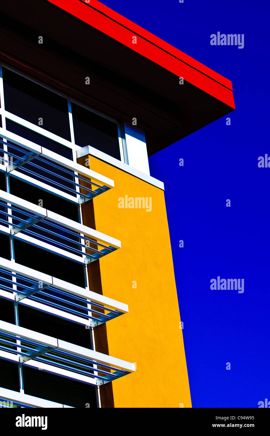 Gold building with white trim with red roof against a saturated blue ...