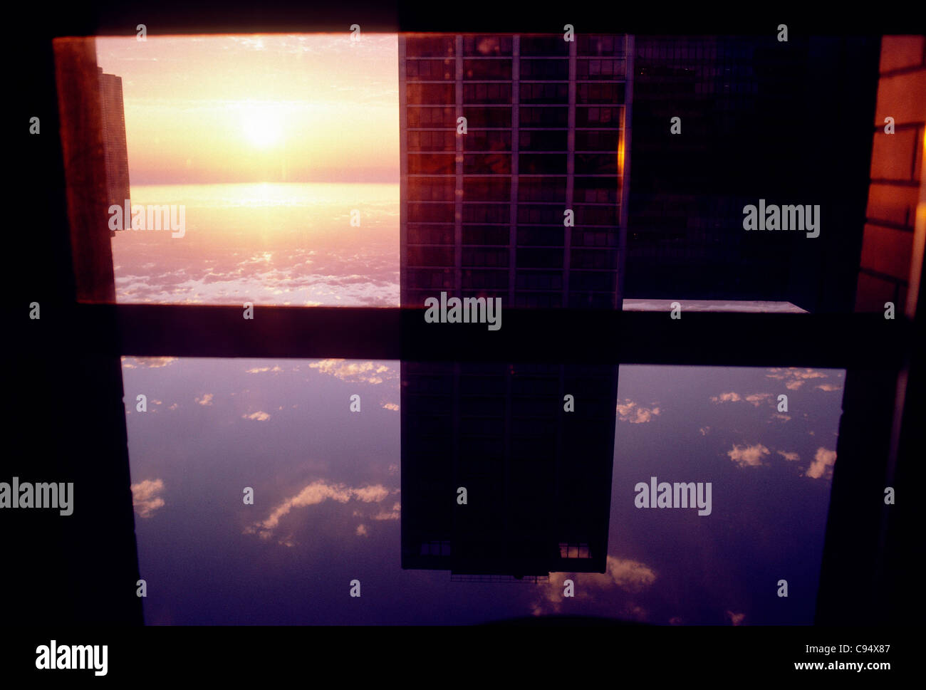 Sunrise view through the window of a high rise hotel in downtown ...