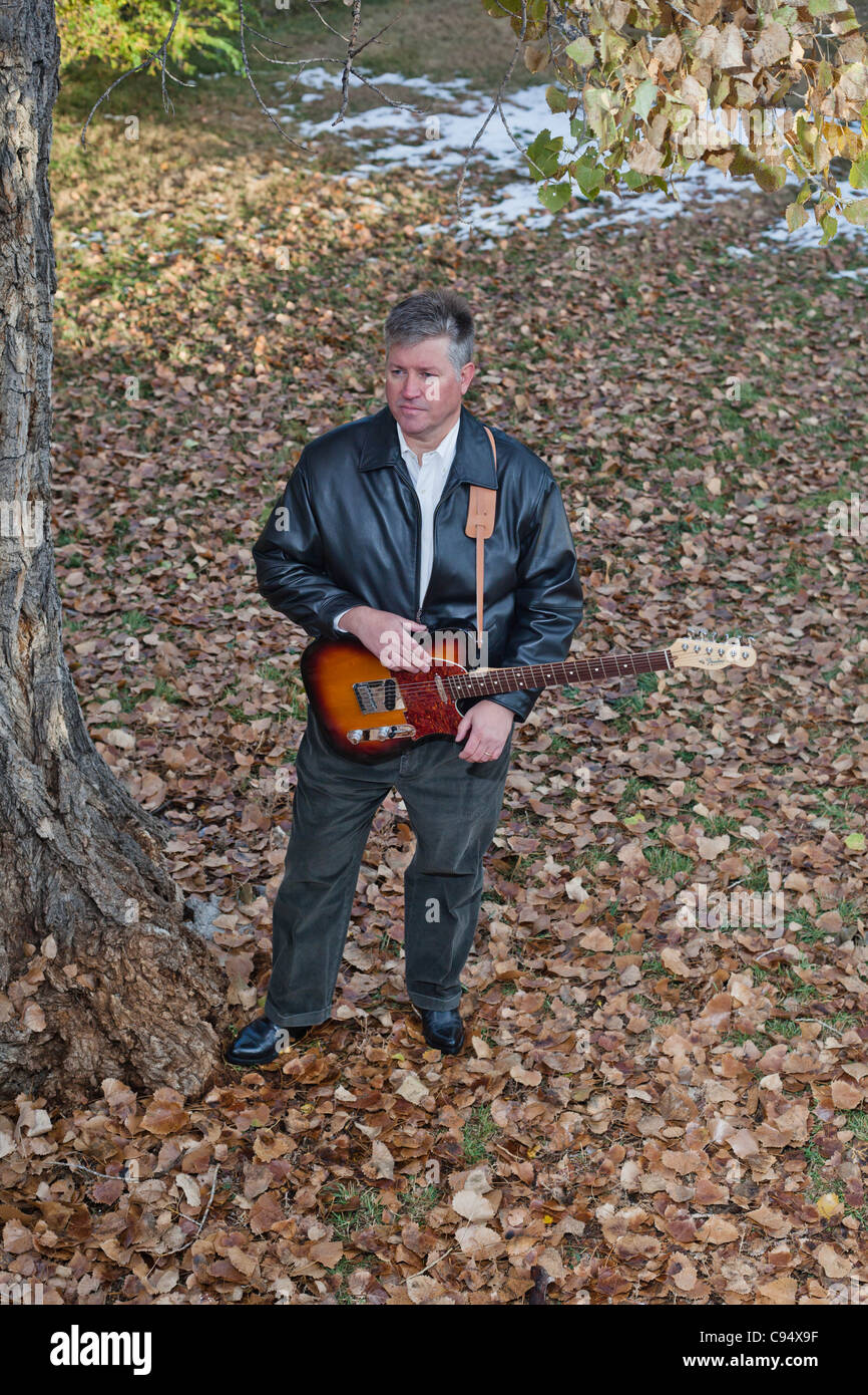 A musician poses with his 1990 Fender Electric guitar in a Fall ...