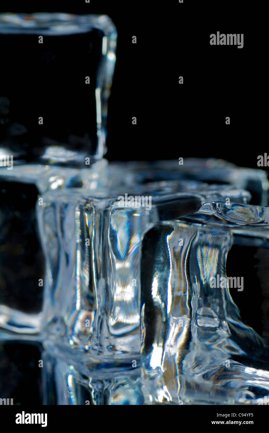 5 ice cube on the black background with reflection Stock Photo - Alamy