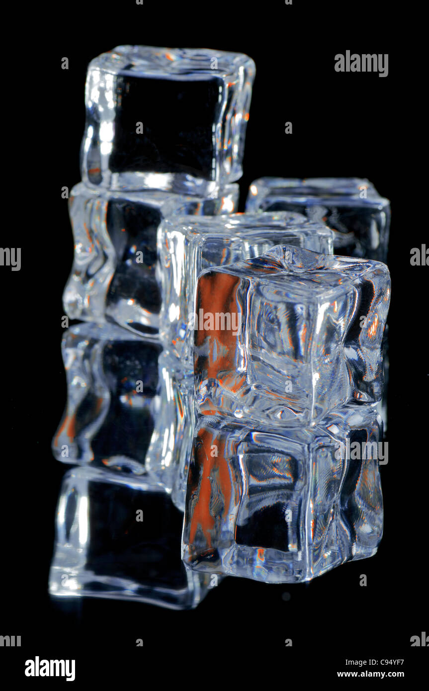 5 ice cube on the black background with flame reflection Stock Photo ...