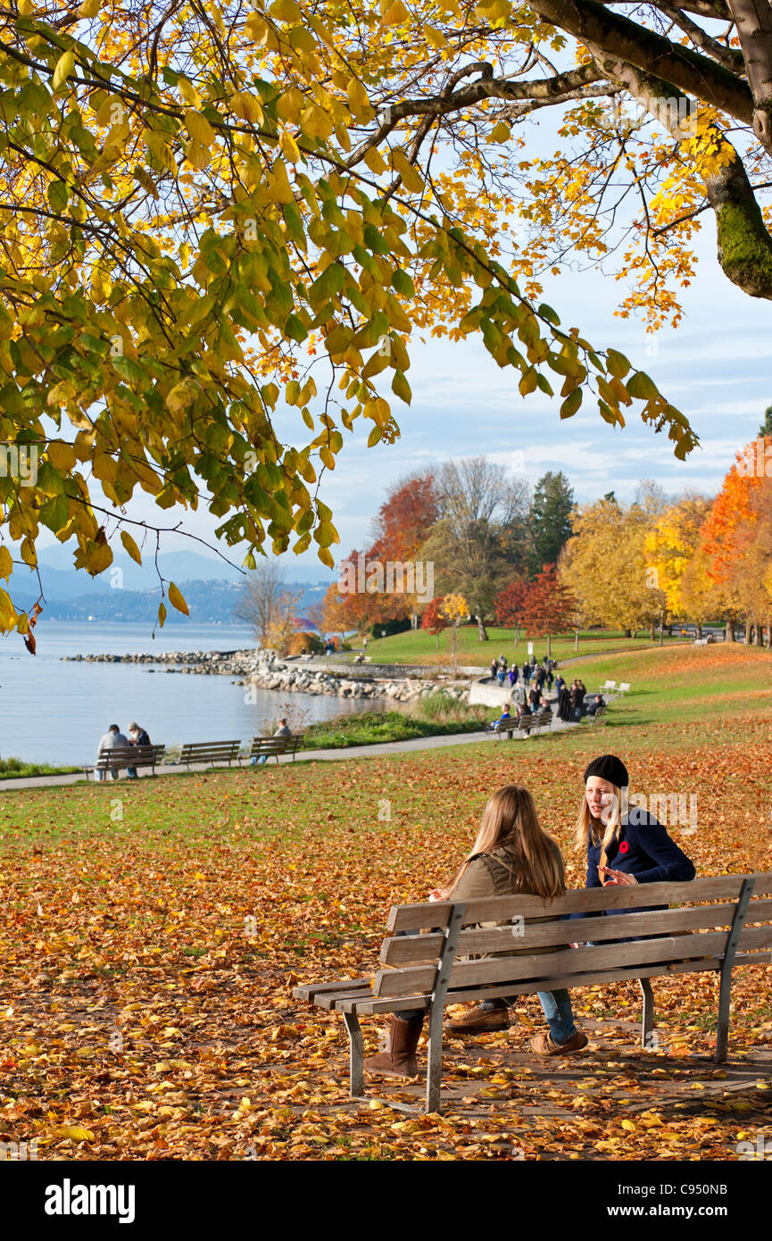Two ladies in the fall park Stock Photo - Alamy