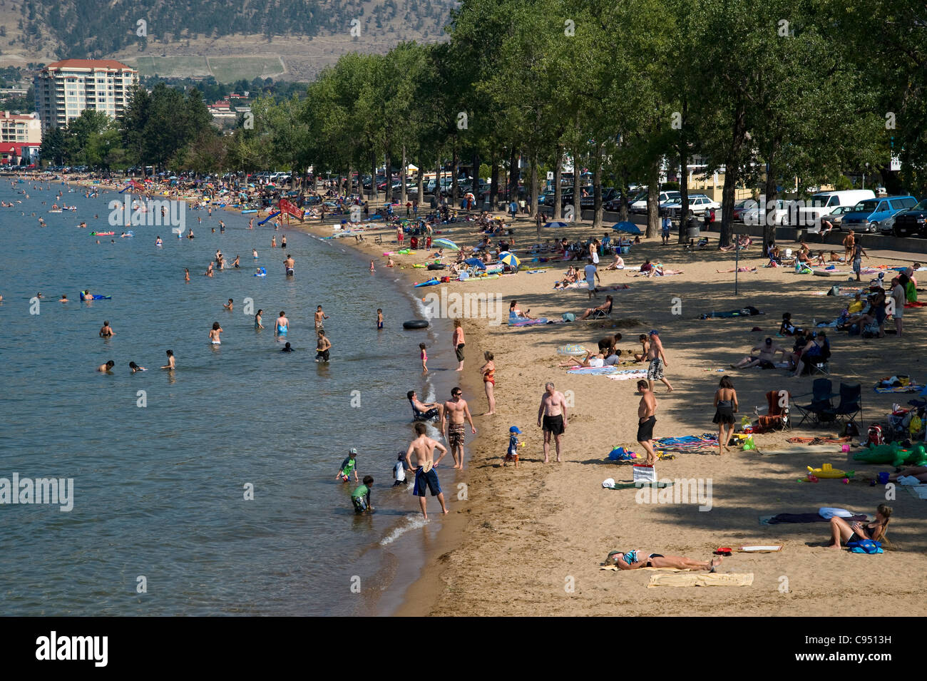 Beach with swimmers by Penticton Stock Photo - Alamy
