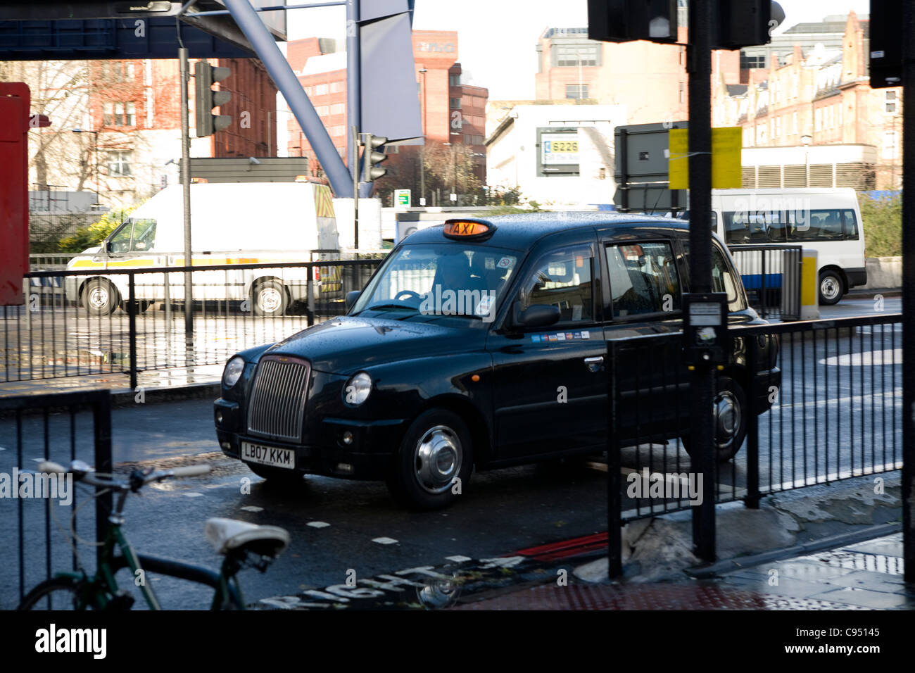 Black cab driving through London street Stock Photo - Alamy