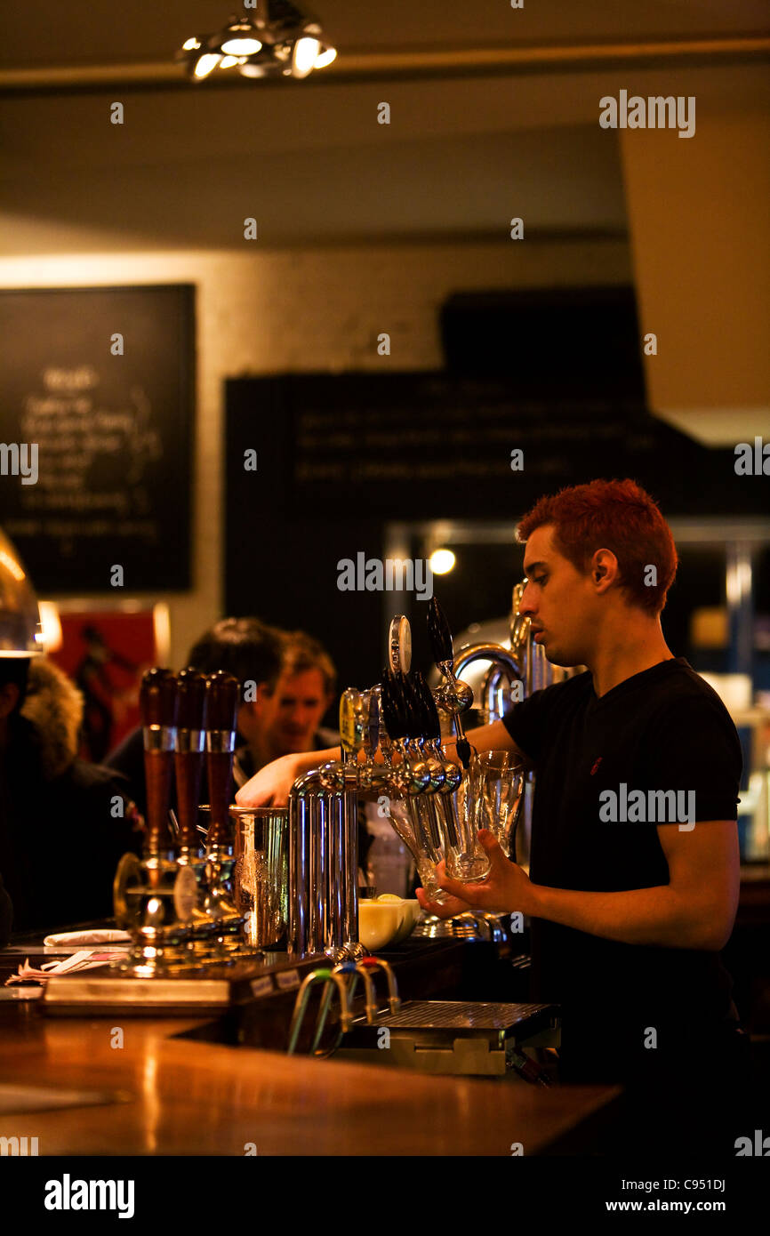 Barman is serving drinks in pub Stock Photo - Alamy