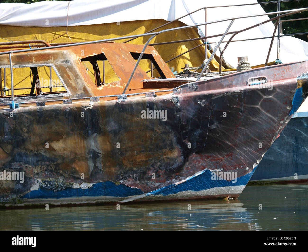 A burnt out boat on the St Helens Canal at Spike Island Stock Photo - Alamy
