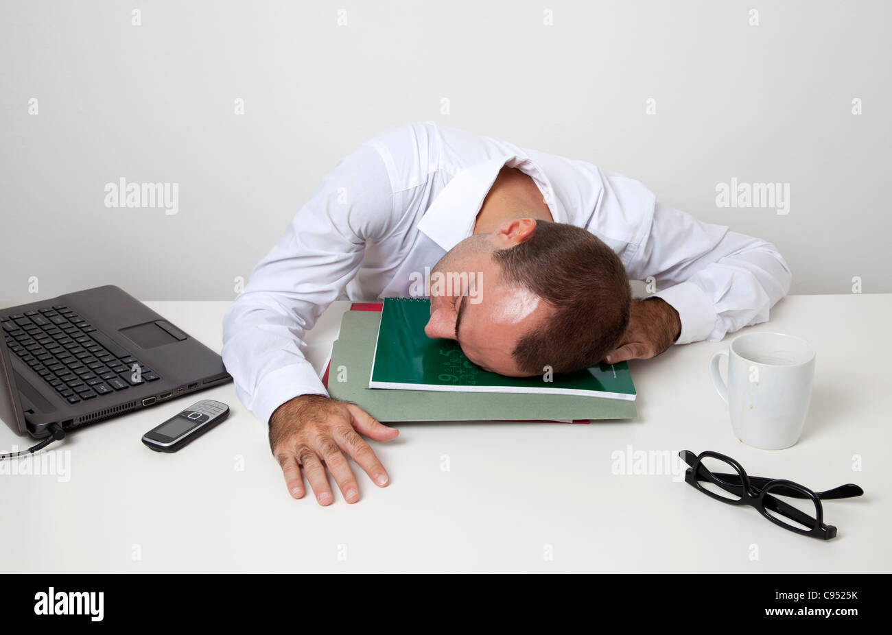 Man asleep at work table Stock Photo - Alamy