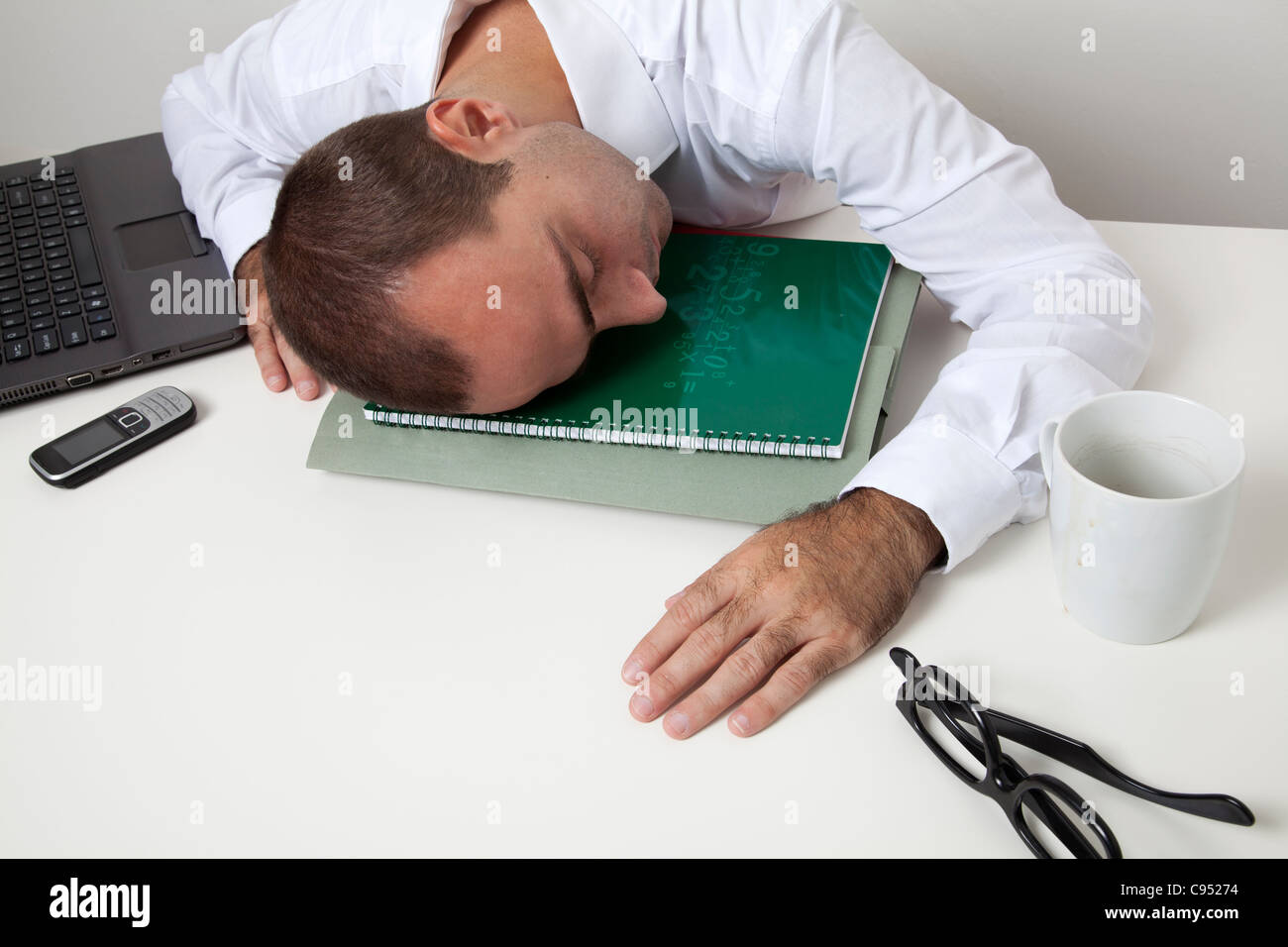 Man asleep at work table Stock Photo - Alamy