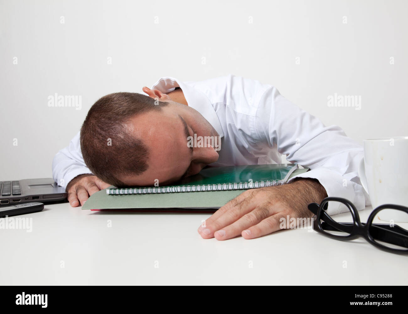Man asleep at work table Stock Photo - Alamy