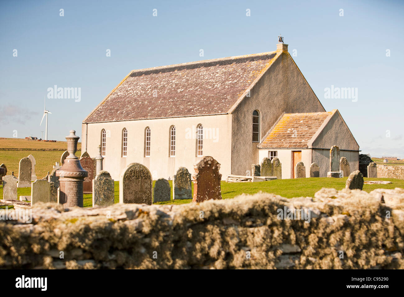 A church on Flotta with an Enercon 2.3 MW wind turbine on Flotta in the ...