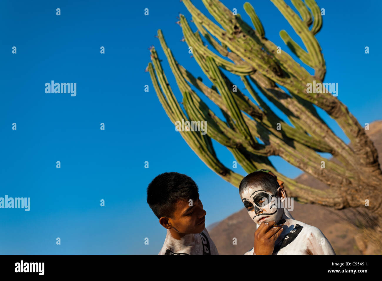 A Cora Indian boy prepares himself for the religious ritual ceremony of ...