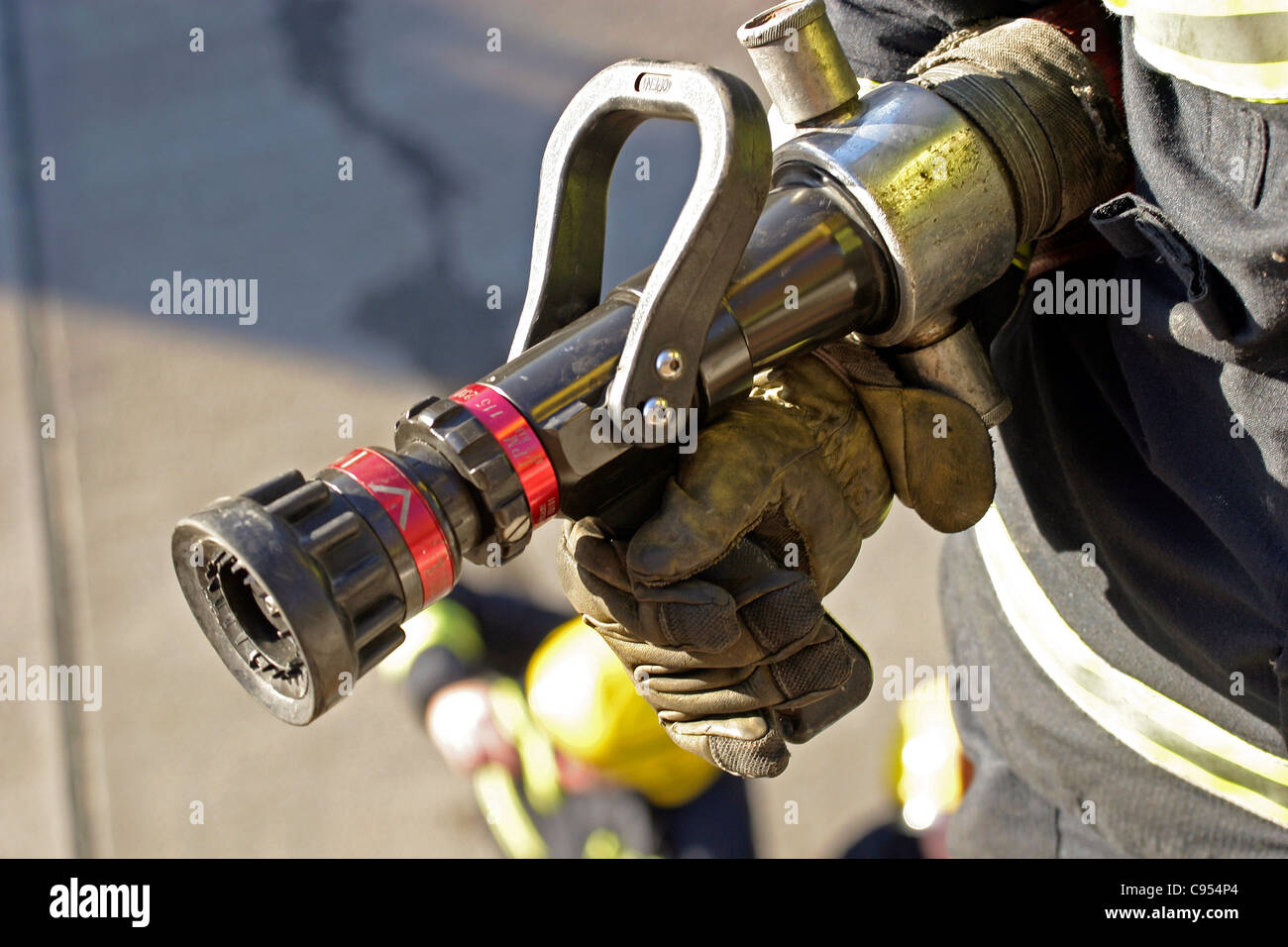 Fireman holding a hose Stock Photo - Alamy