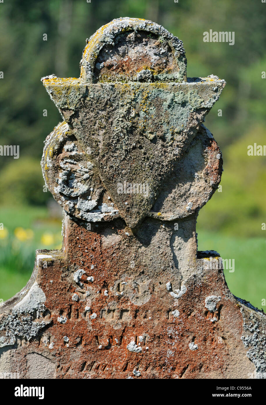Detail of eroded gravestone with trefoil and triangle motif. Church of ...