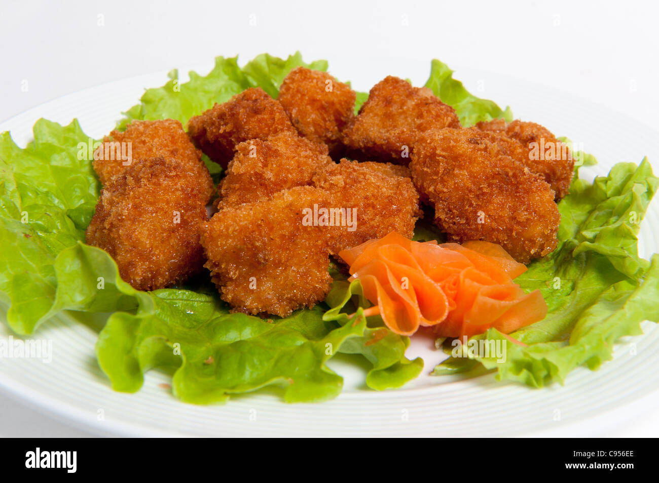 Battered fish on a plate isolated on white background Stock Photo - Alamy