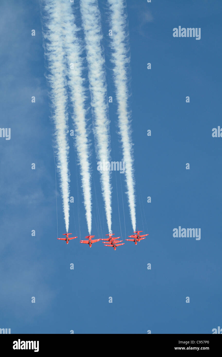 Red Arrow display team trailing white smoke against a blue sky Stock ...