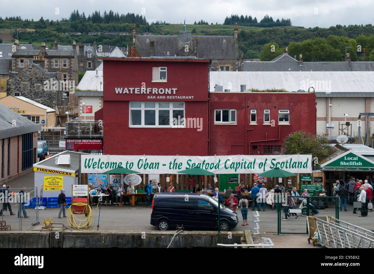 The view from a ferry in Oban harbour looking towards the quayside in ...