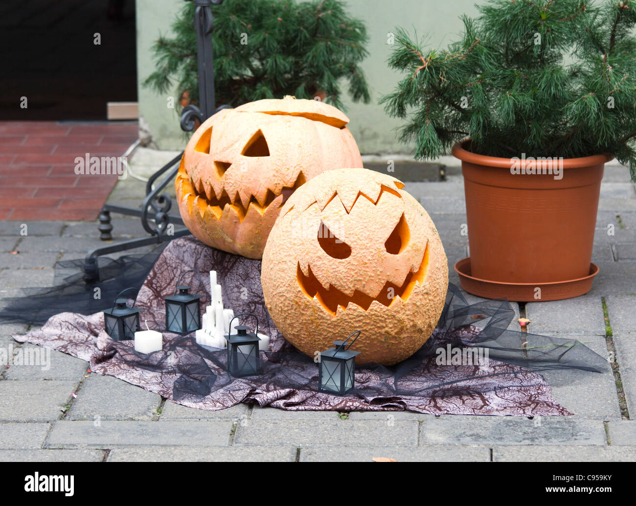 Street scene: Two Halloween carved pumpkins with amusing grins on a ...