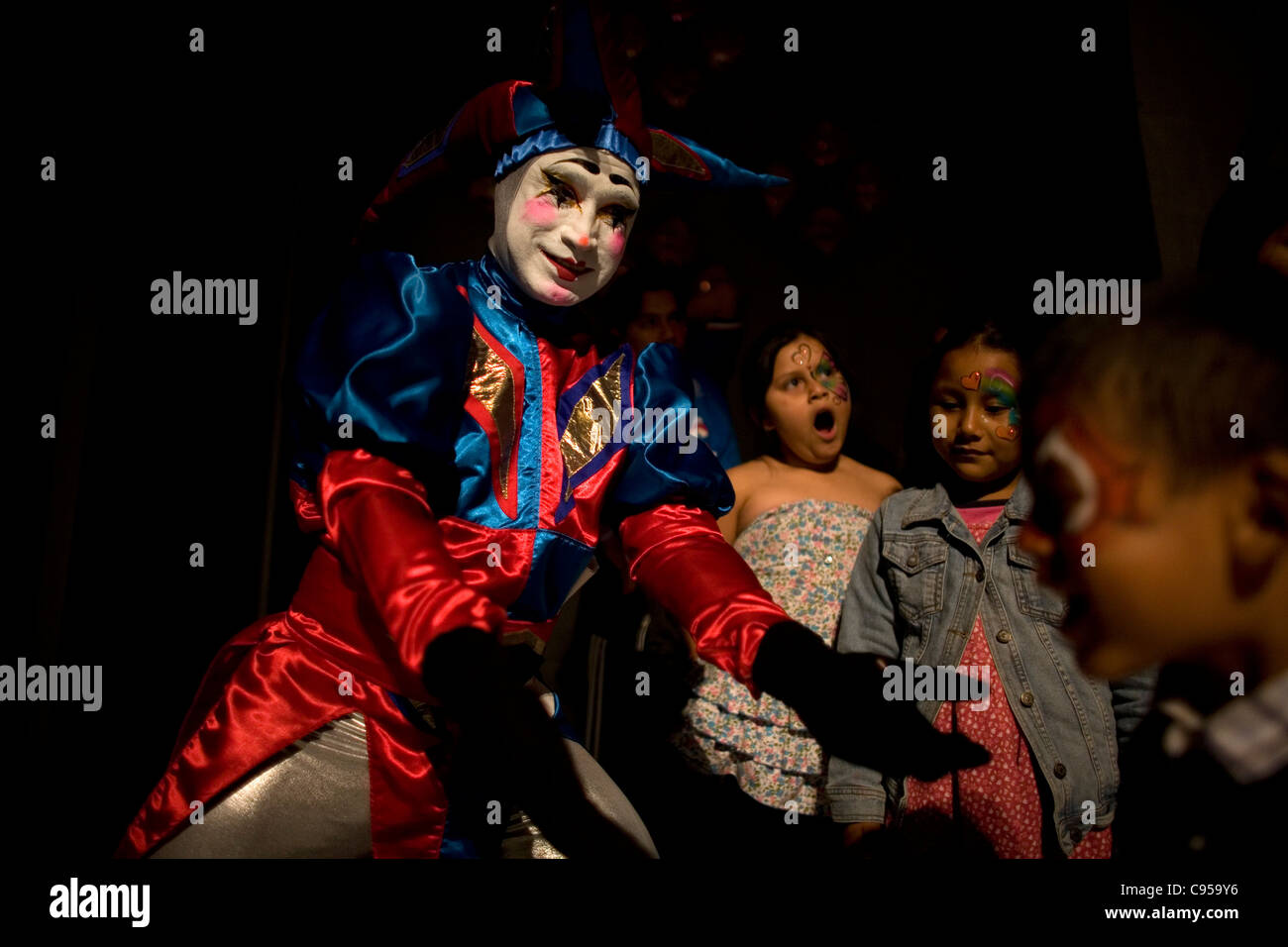 A jester clown plays with children during the 16th International Clown ...