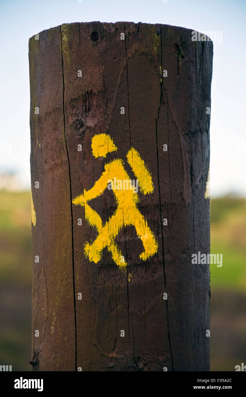 Symbol of a walker on fence post Stock Photo - Alamy