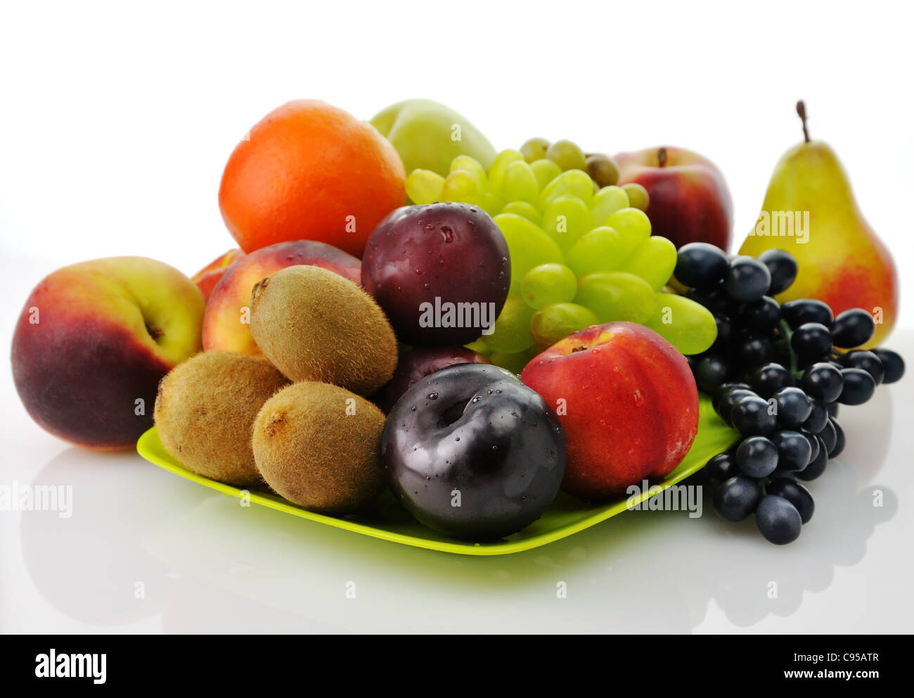 assortment of fresh fruits on a green dish Stock Photo - Alamy