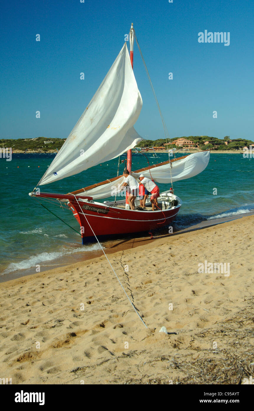 Old classical Latin sail boat landing at Porto Pollo beach, Palau ...
