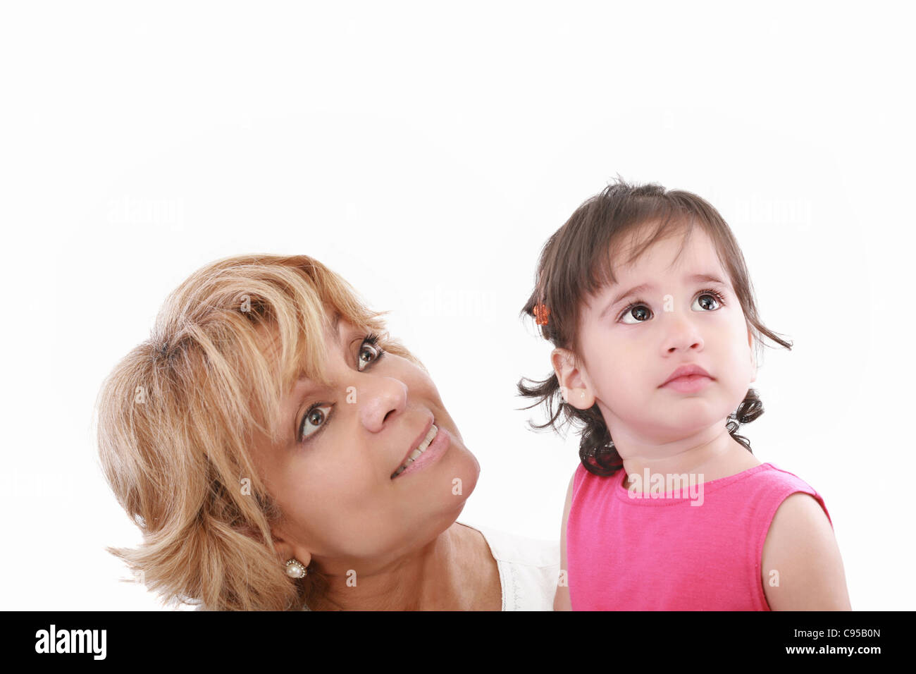 Cute girl and attractive young woman both looking up Stock Photo - Alamy