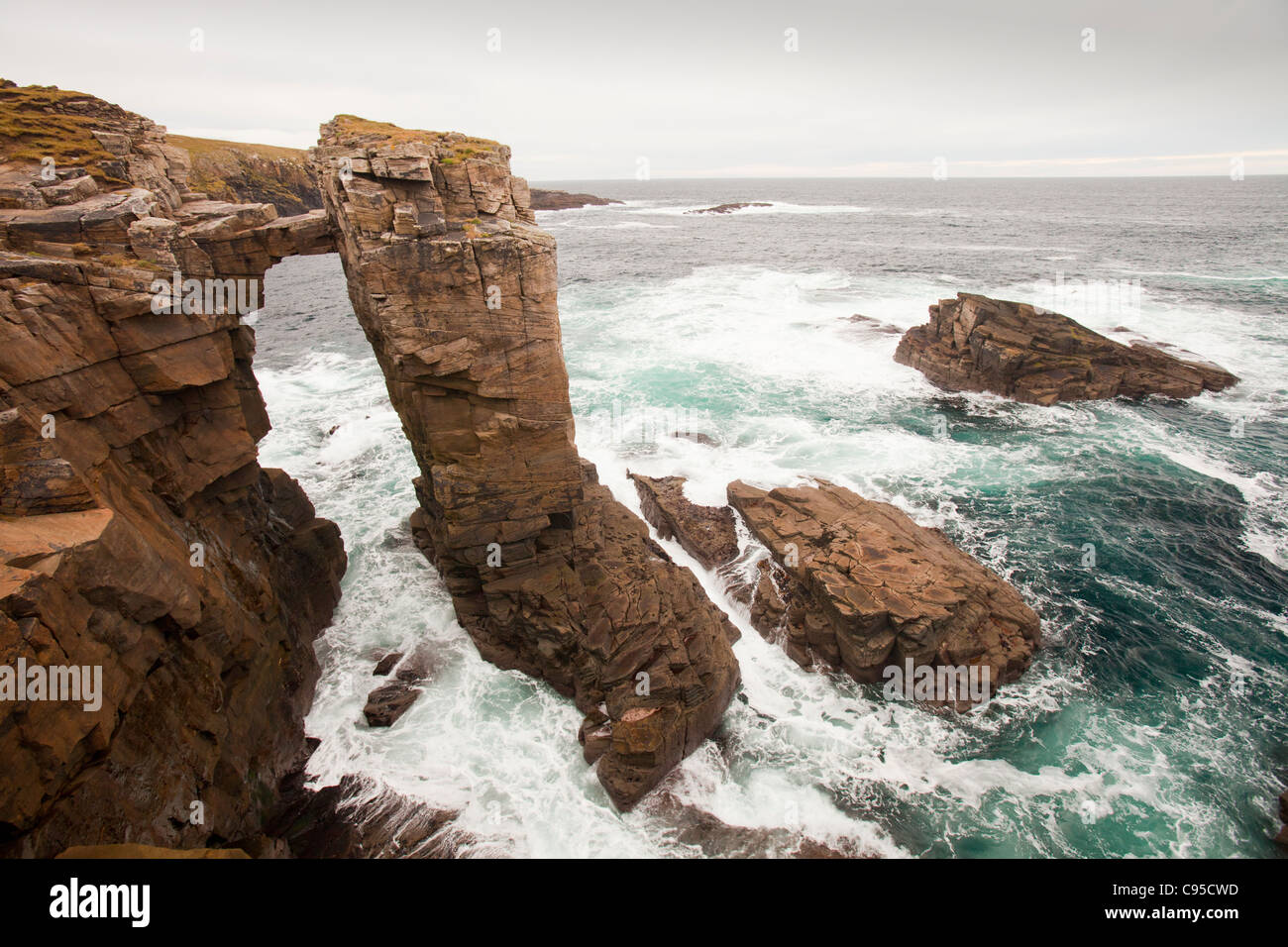 A chock stone bridge that links the sea cliffs to a sea stack at ...