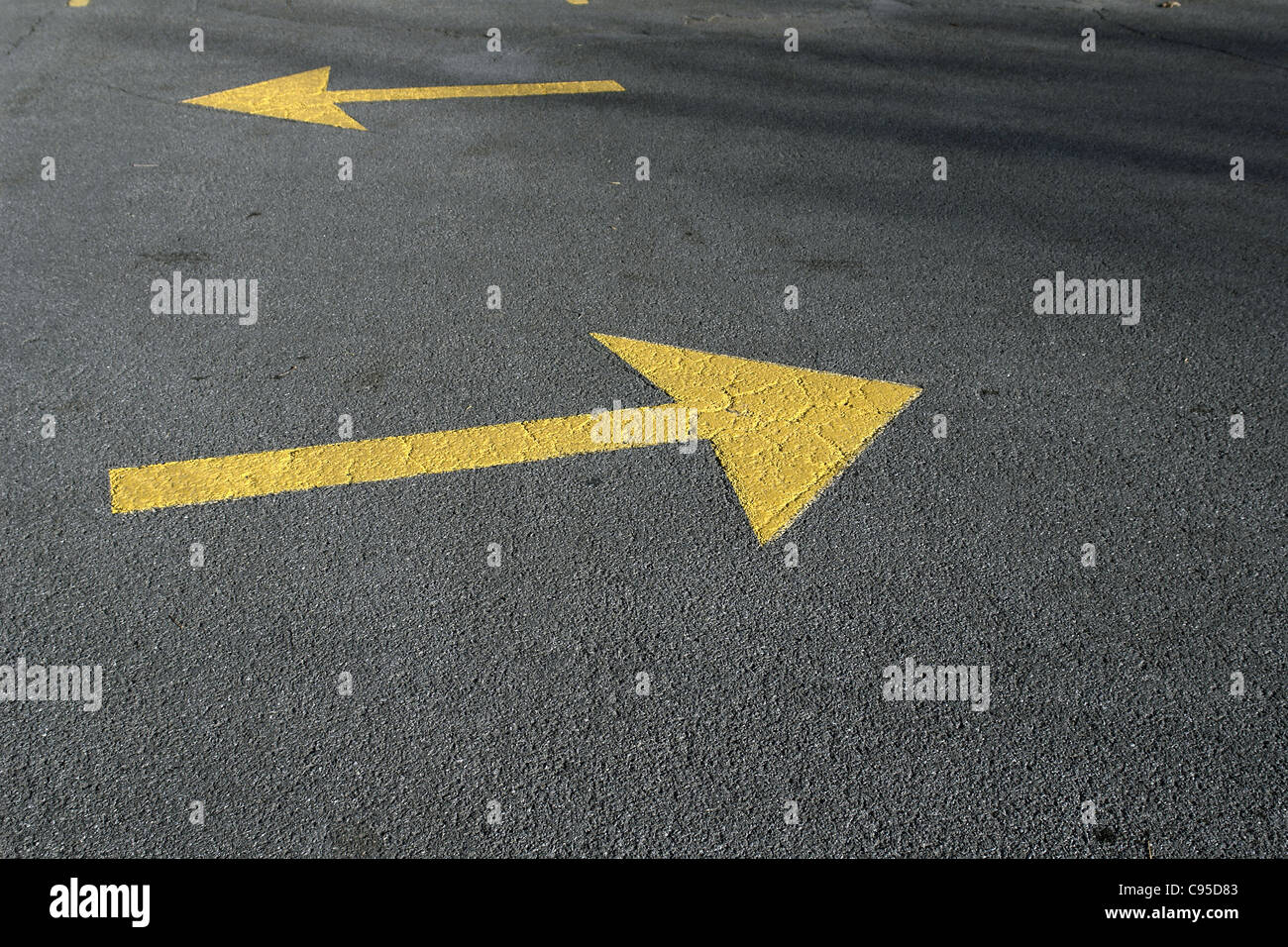 Photograph of Two Yellow Directional Arrows on Road Pavement Copy Space ...