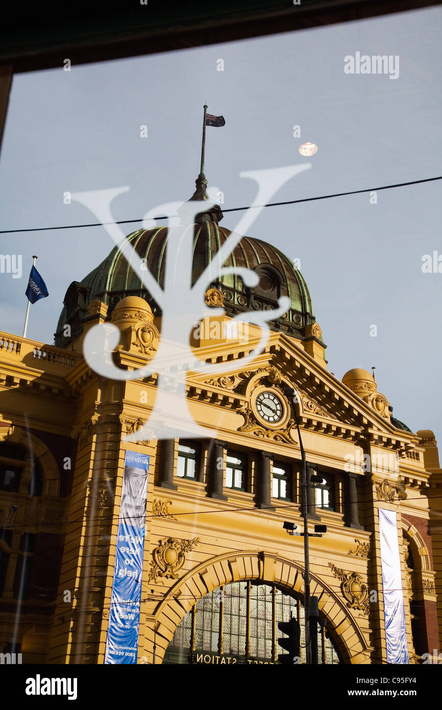 Flinders Street Station is reflected in the window of Young and Jackson ...