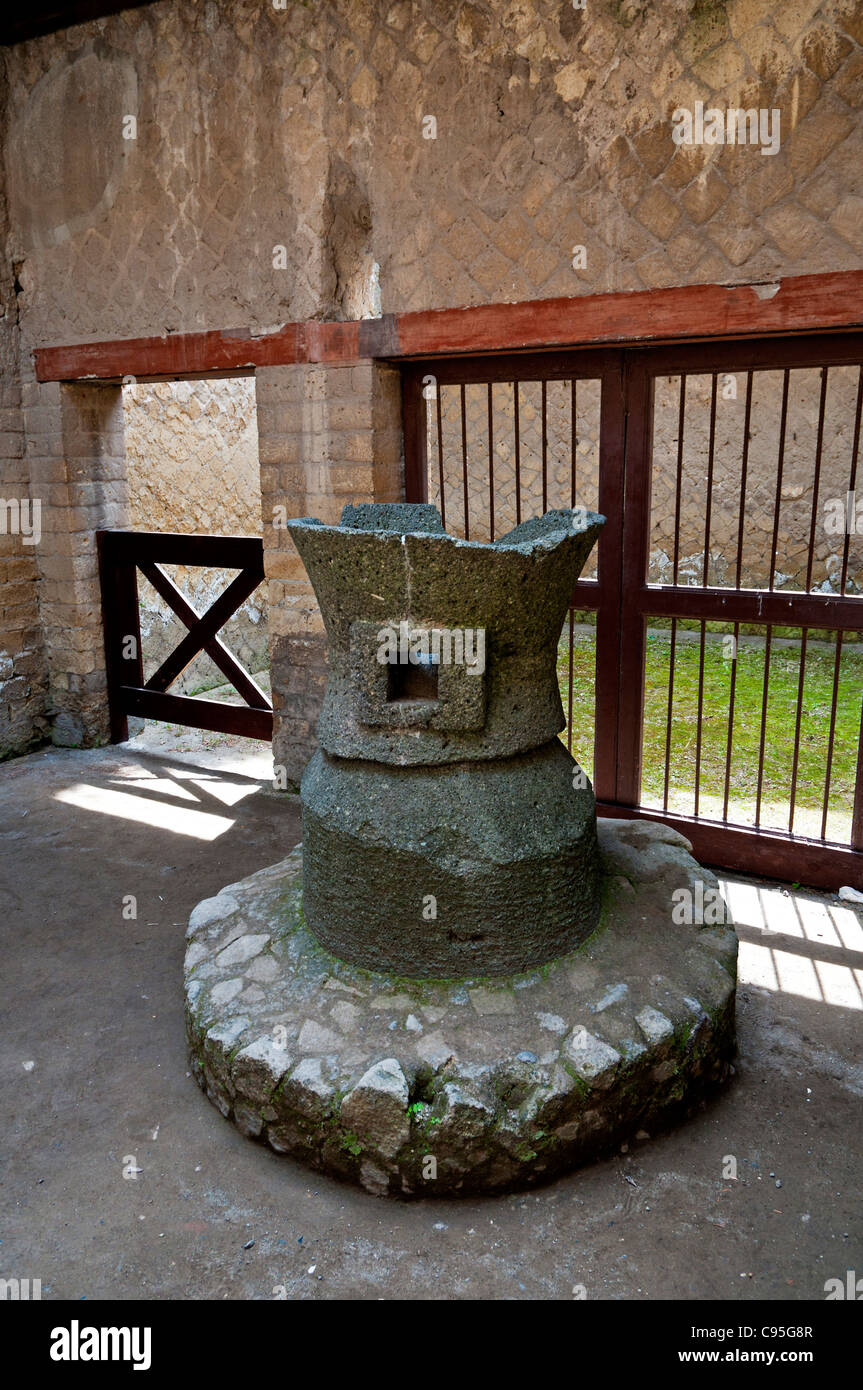 An ancient grindstone in the excavated town bakery, Herculaneum, Italy ...