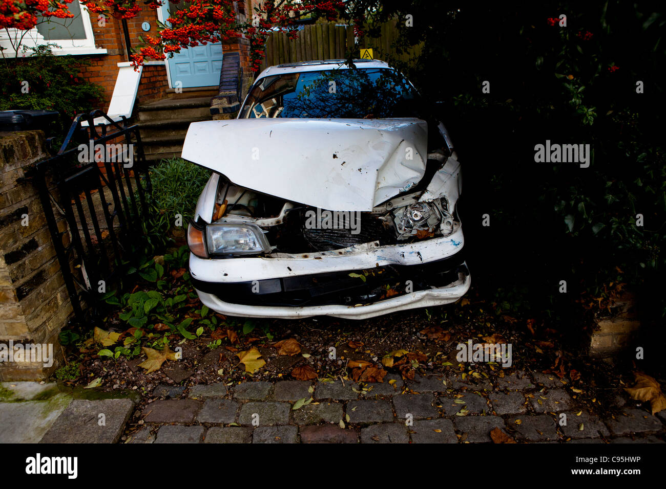 Crashed car in driveway Stock Photo - Alamy