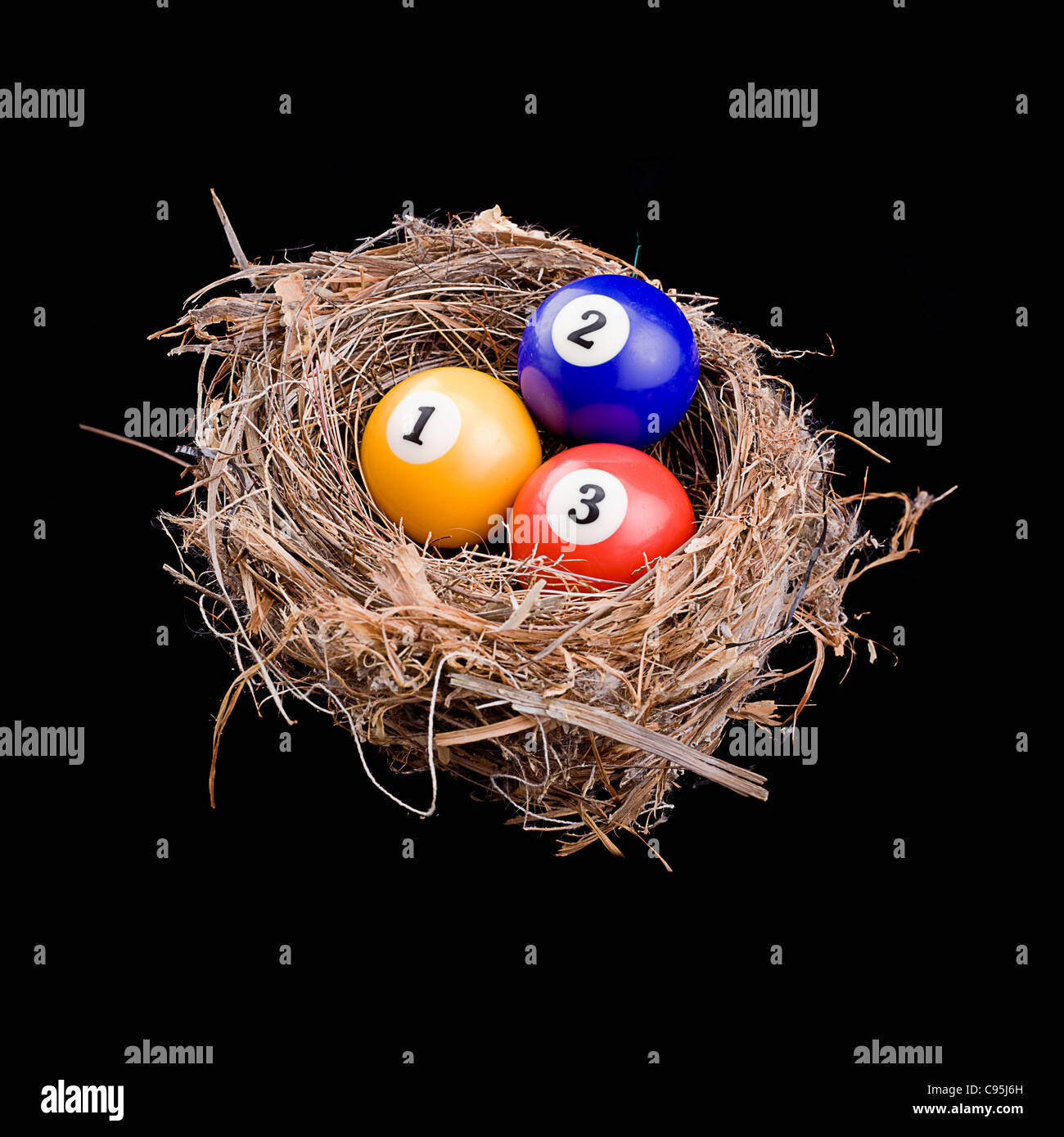 3 x snooker / pool balls inside a birds nest Stock Photo - Alamy