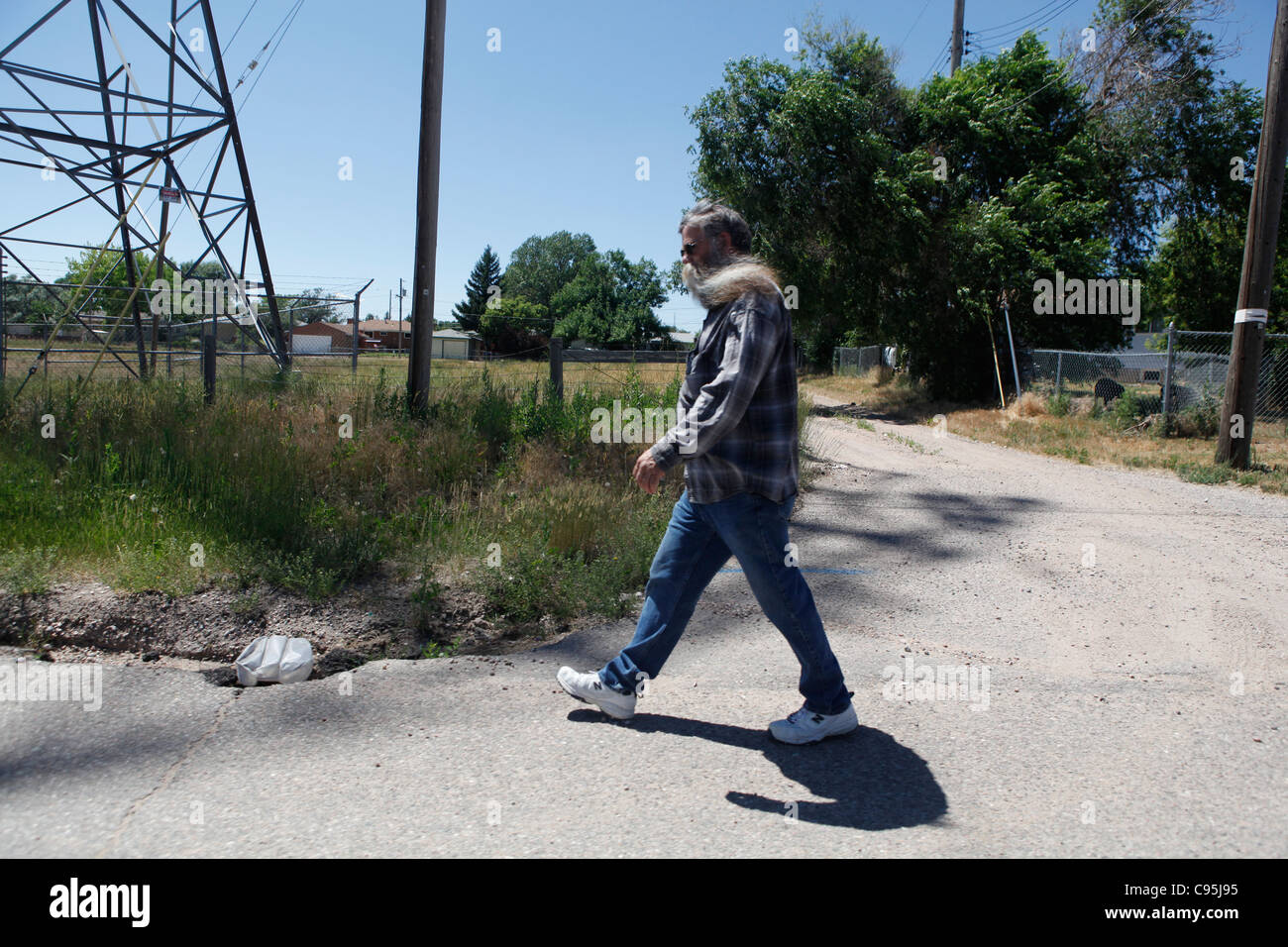 old man with beard walking under powerlines cheyenne wyoming boomers ...