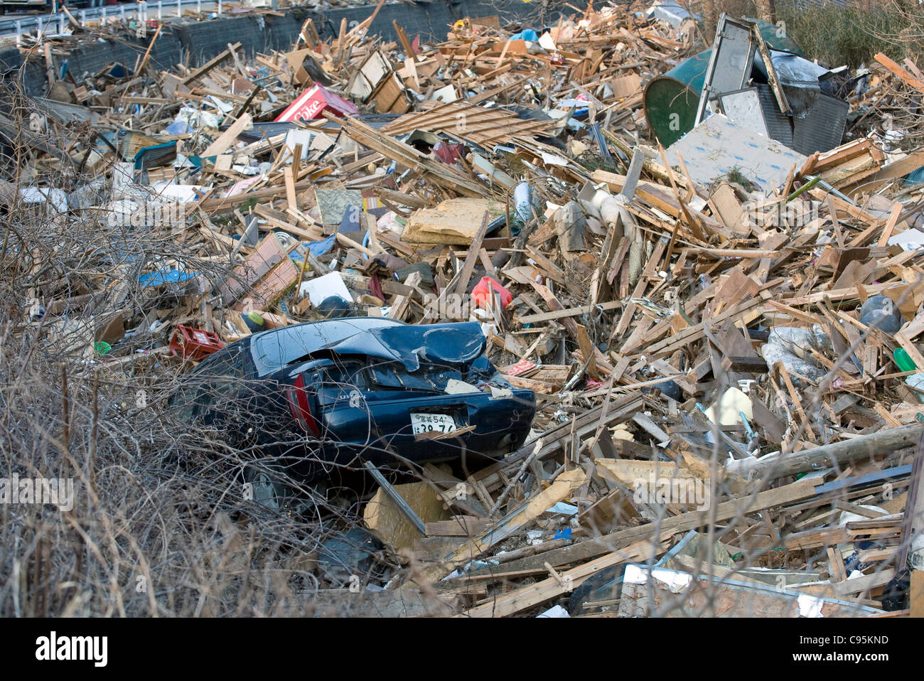 A battered vehicle is among the debris that has collected in an estuary ...
