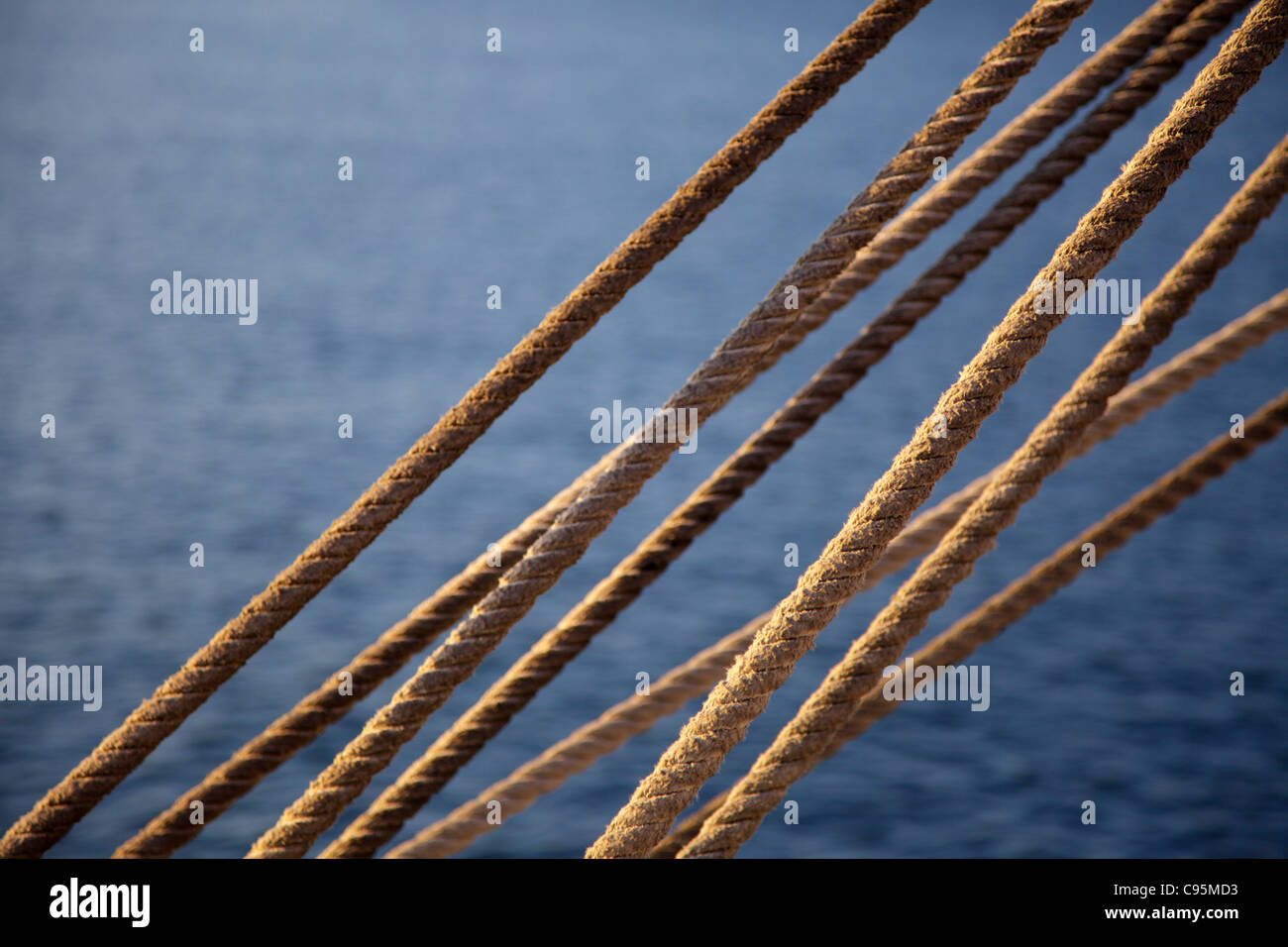 view of a blue sea through the wires, rope Stock Photo - Alamy
