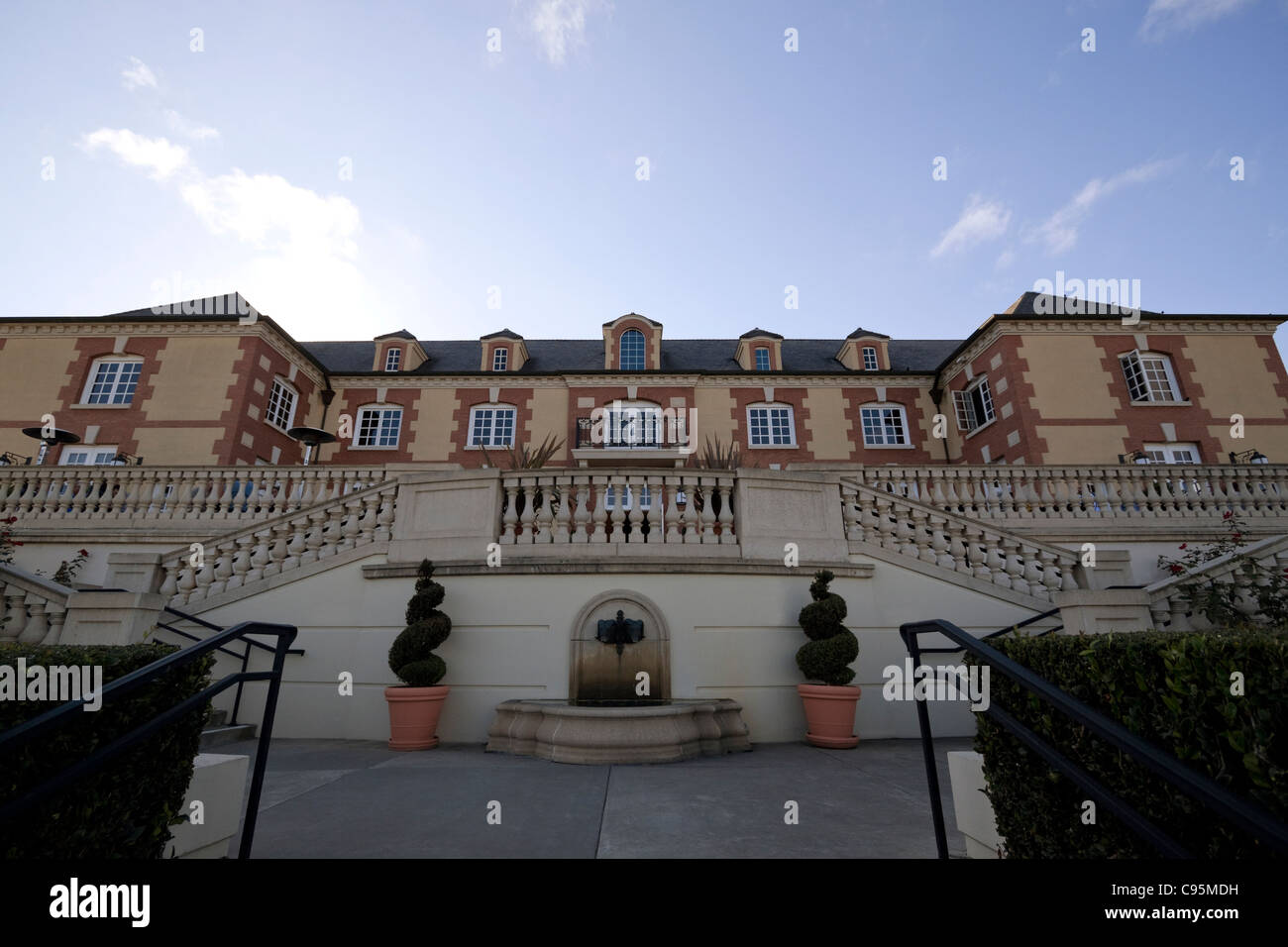 A very large old estate at the top of a hill with several windows Stock ...